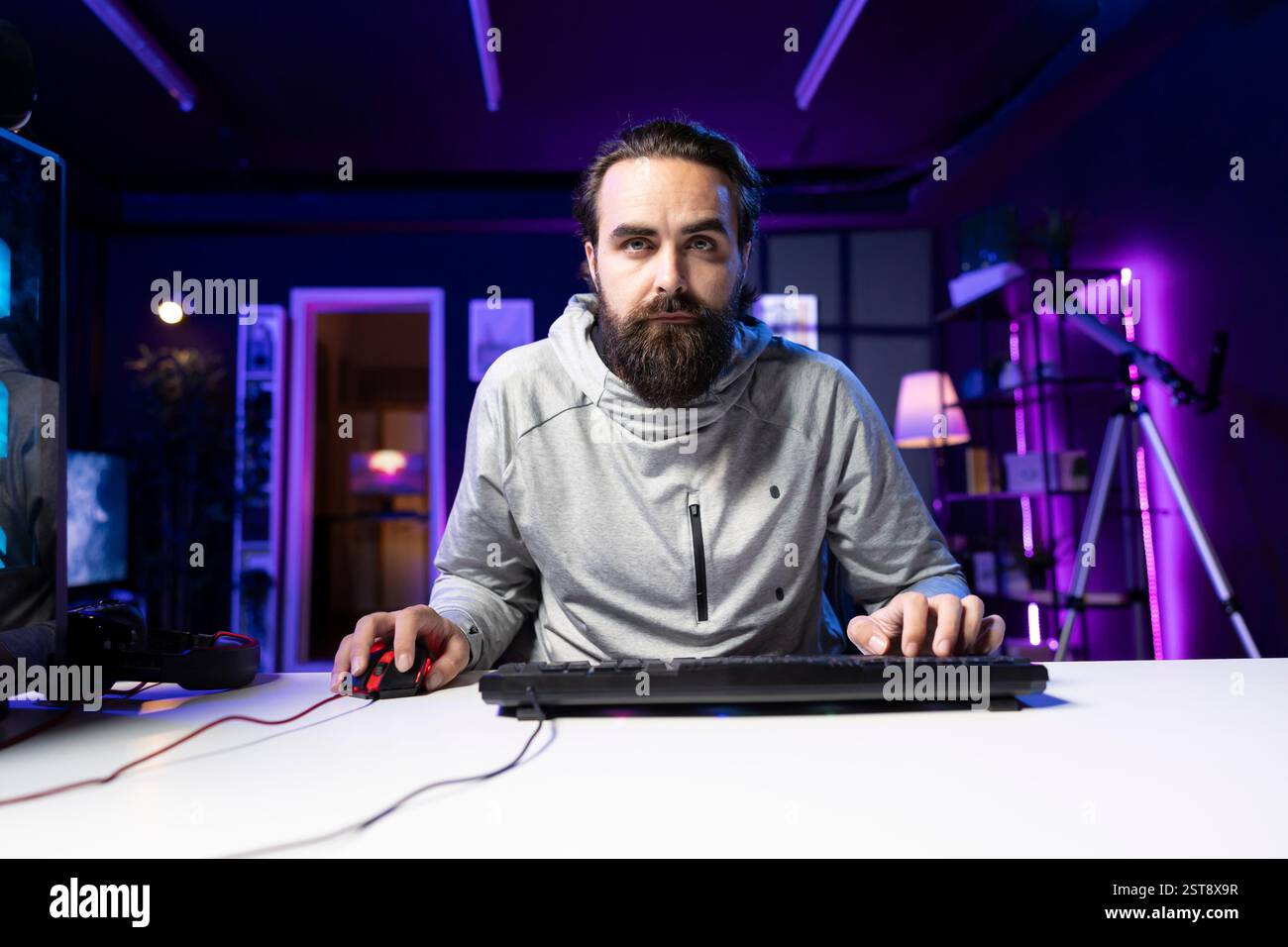 Focused man using gaming mouse and keyboard to shoot enemies in ...