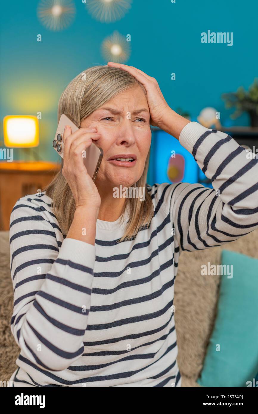 Mature upset anxious frustrated woman listening bad news talking on ...