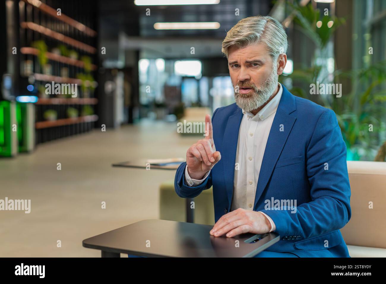 Portrait of mature businessman shakes finger and saying No be careful ...