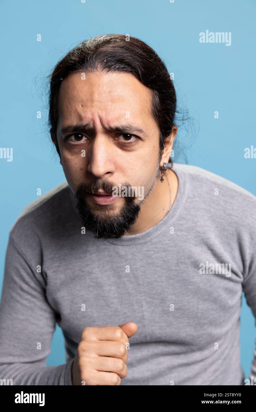 Serious person acting curious and skeptical at the same time, wearing ...