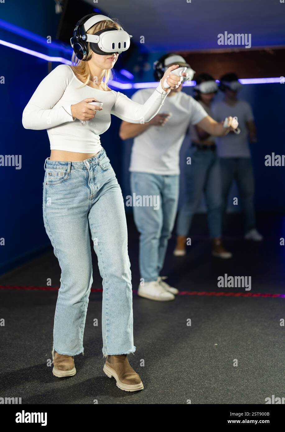Girl learning dance movement in VR helmet Stock Photo - Alamy
