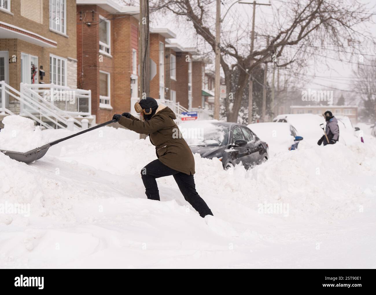 Montreal, Canada. 17th Feb, 2025. People shovel snow to dig out their ...