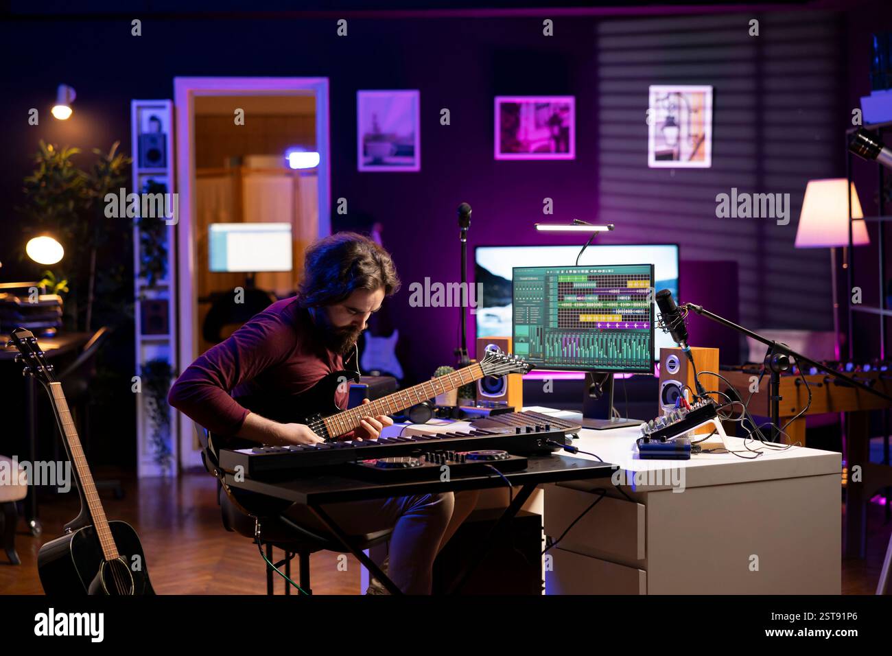 Sound engineer recording his acoustic guitar accords in home studio ...