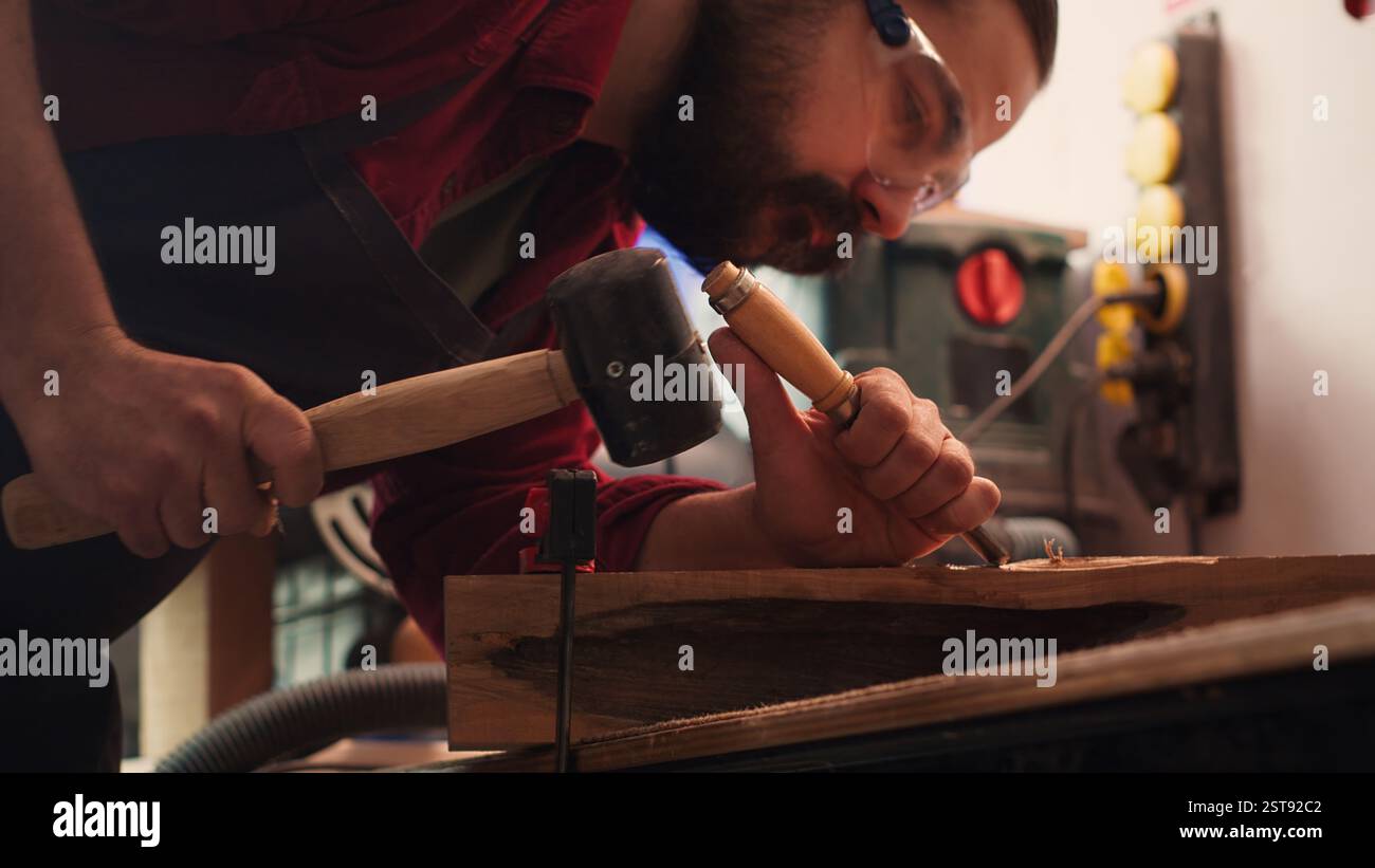 Artisan using bench vise to hold timber block, carving intricate ...