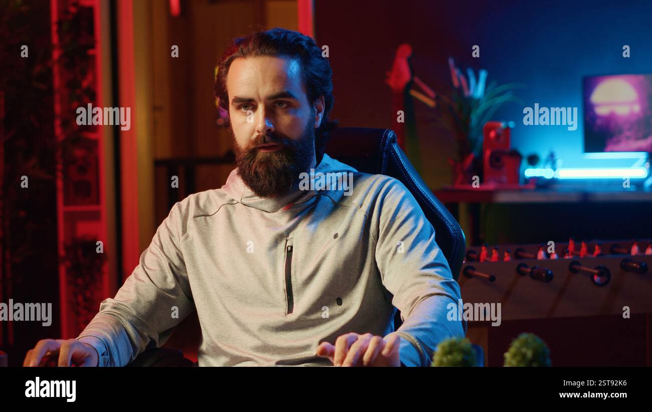 Stressed man playing videogames at home, struggling to keep up with ...