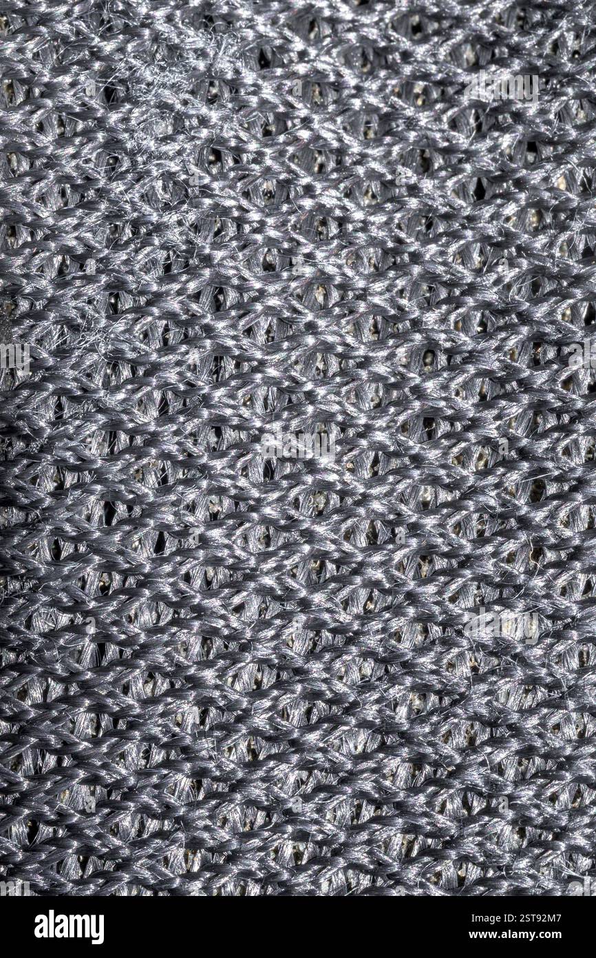 Background detail of shiny silver fabric braiding in vertical Stock ...
