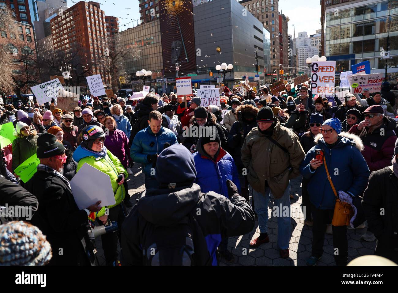 People gather for a rally chant opposition to the policies of President ...