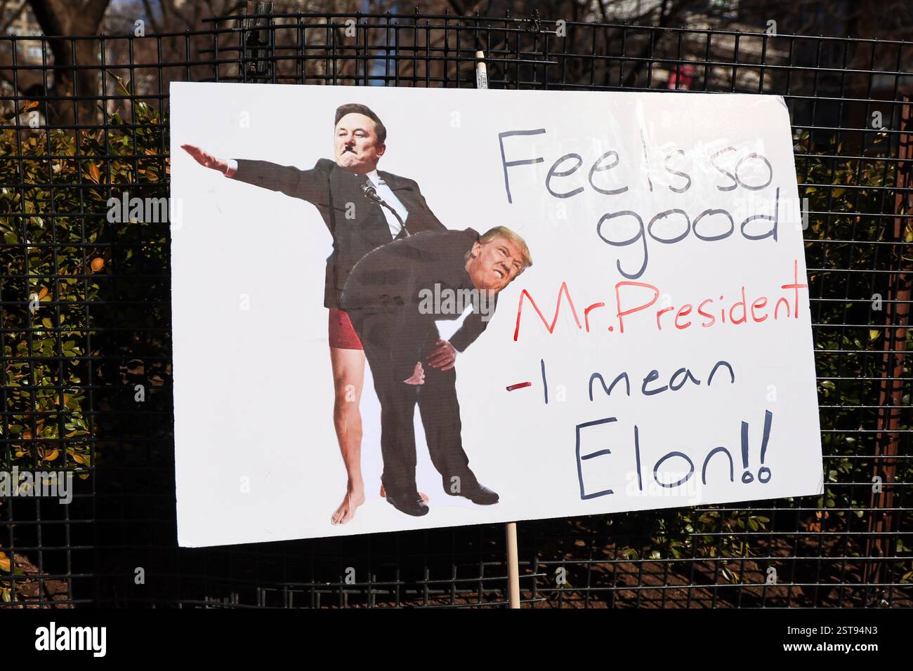 A sign opposed to the policies of President Donald Trump and Elon Musk ...