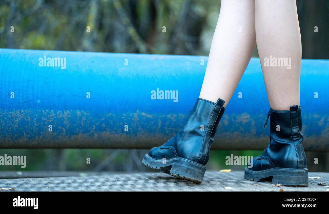 Step into Style. Young lady legs. wearing black boots Stock Photo - Alamy