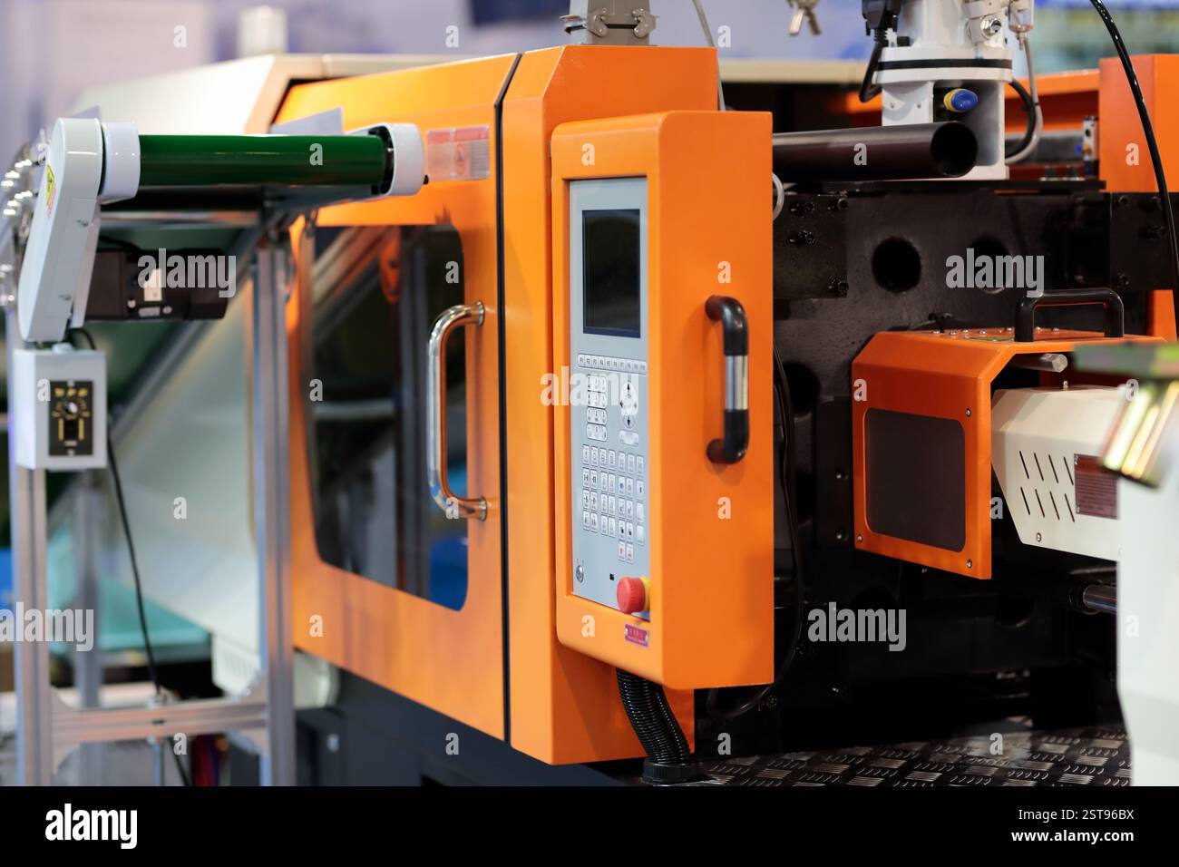 Plastic injection molding machine and conveyor belt. Selective focus ...