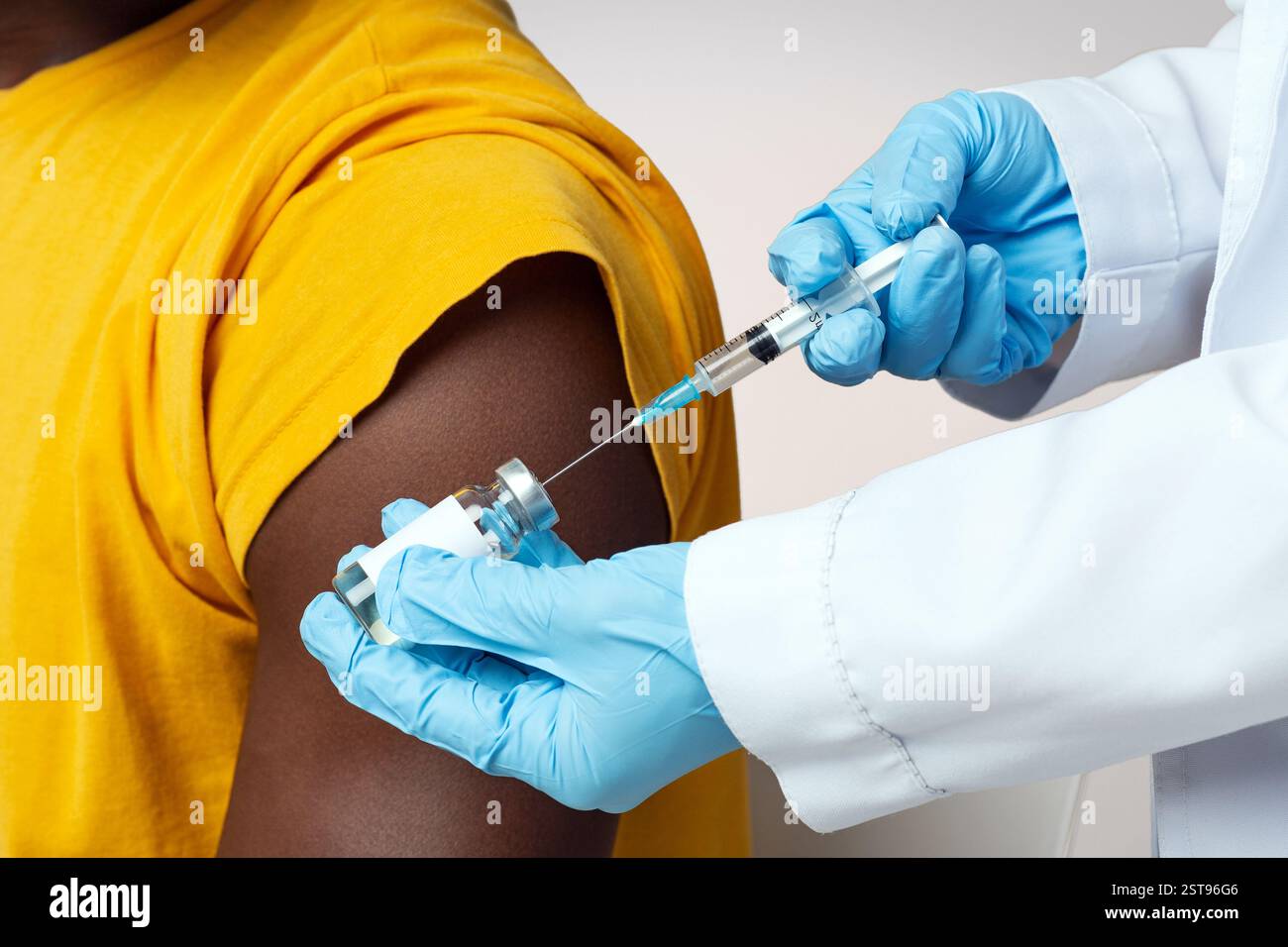 Doctor With Syringe Taking Vaccine From Vial, Making Injection To Black ...