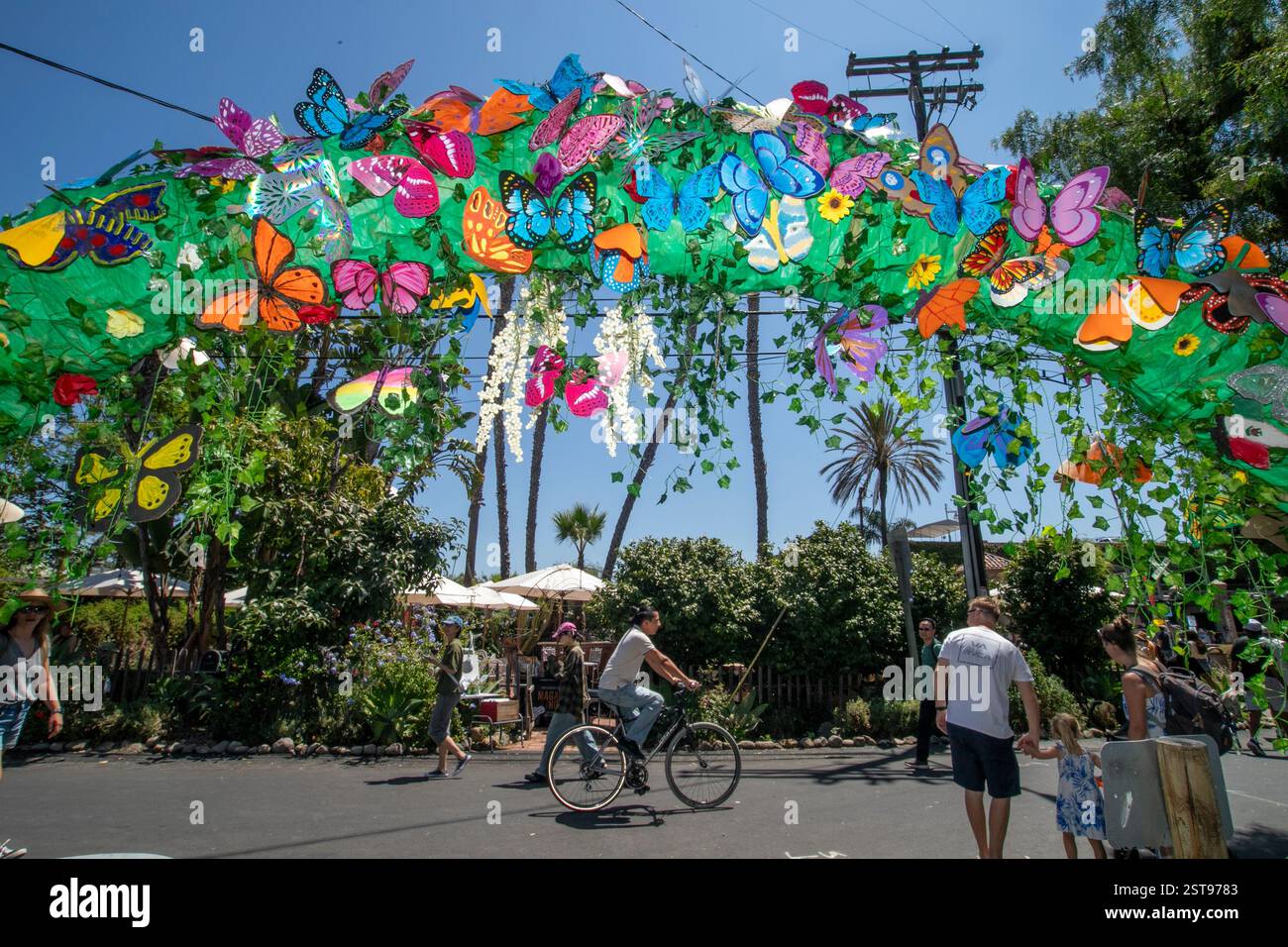 An elaborate entrance arch depicting flowers and butterflies invites ...