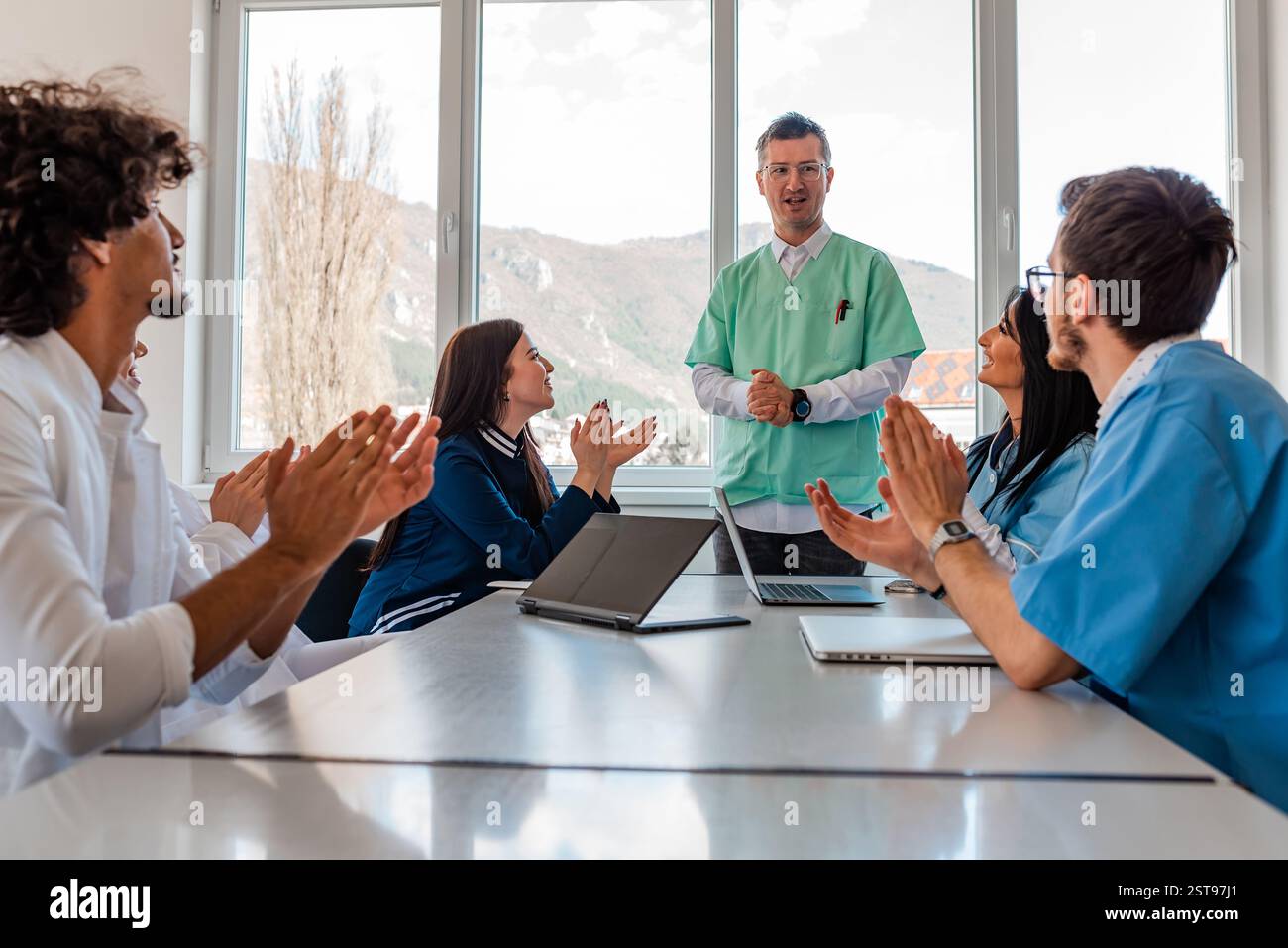 Medical team talking together applauding hi-res stock photography and ...