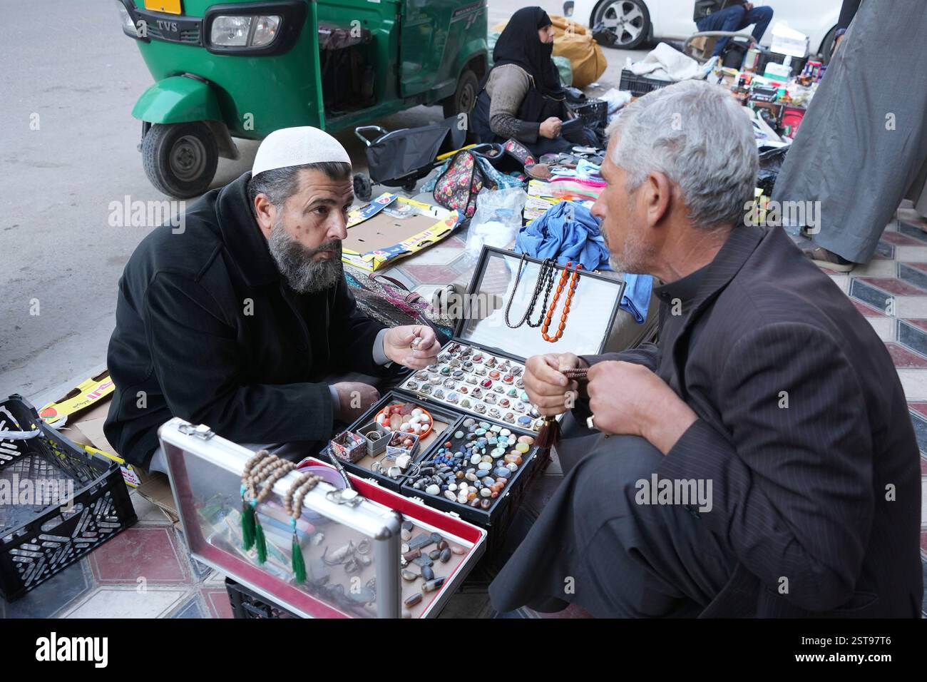An Iranian street vendor wait for customers in the main market to sell ...