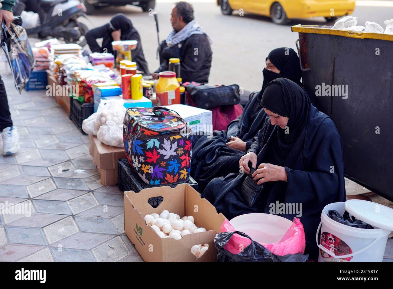 Iranian street vendors wait for customers in the main market to sell ...