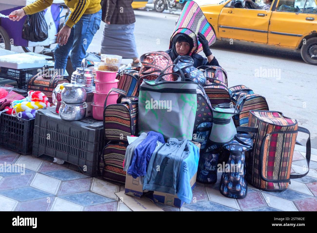 An Iranian street vendor waits for customers in the main market to sell ...