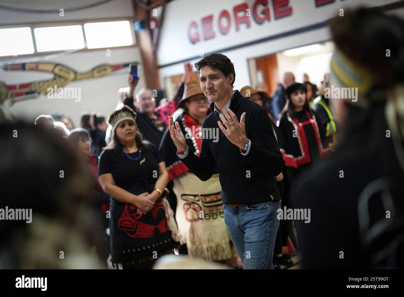 Canadian Prime Minister Justin Trudeau raises his hands as he arrives ...