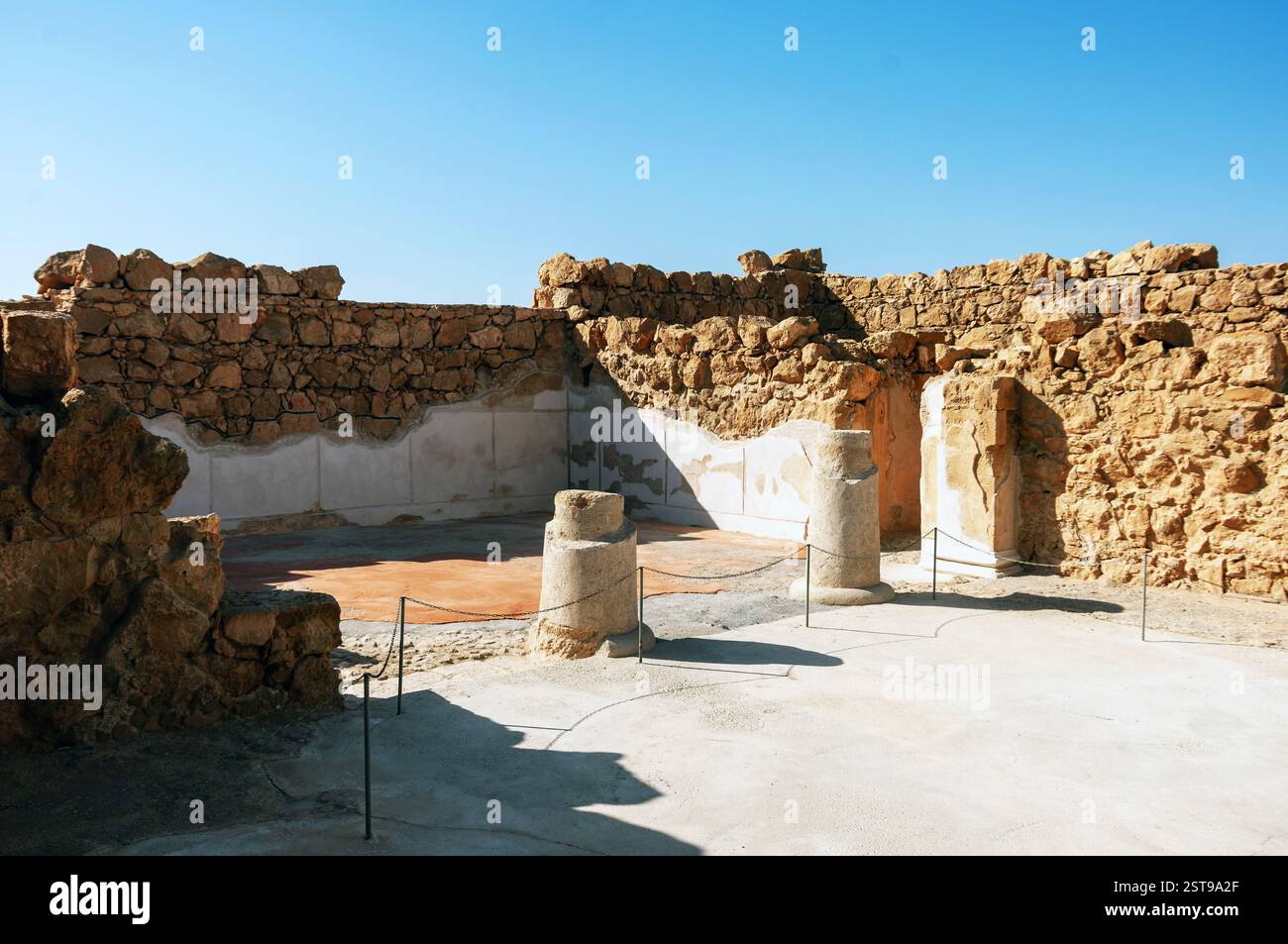 A stone building with a courtyard in the middle. The courtyard is empty ...