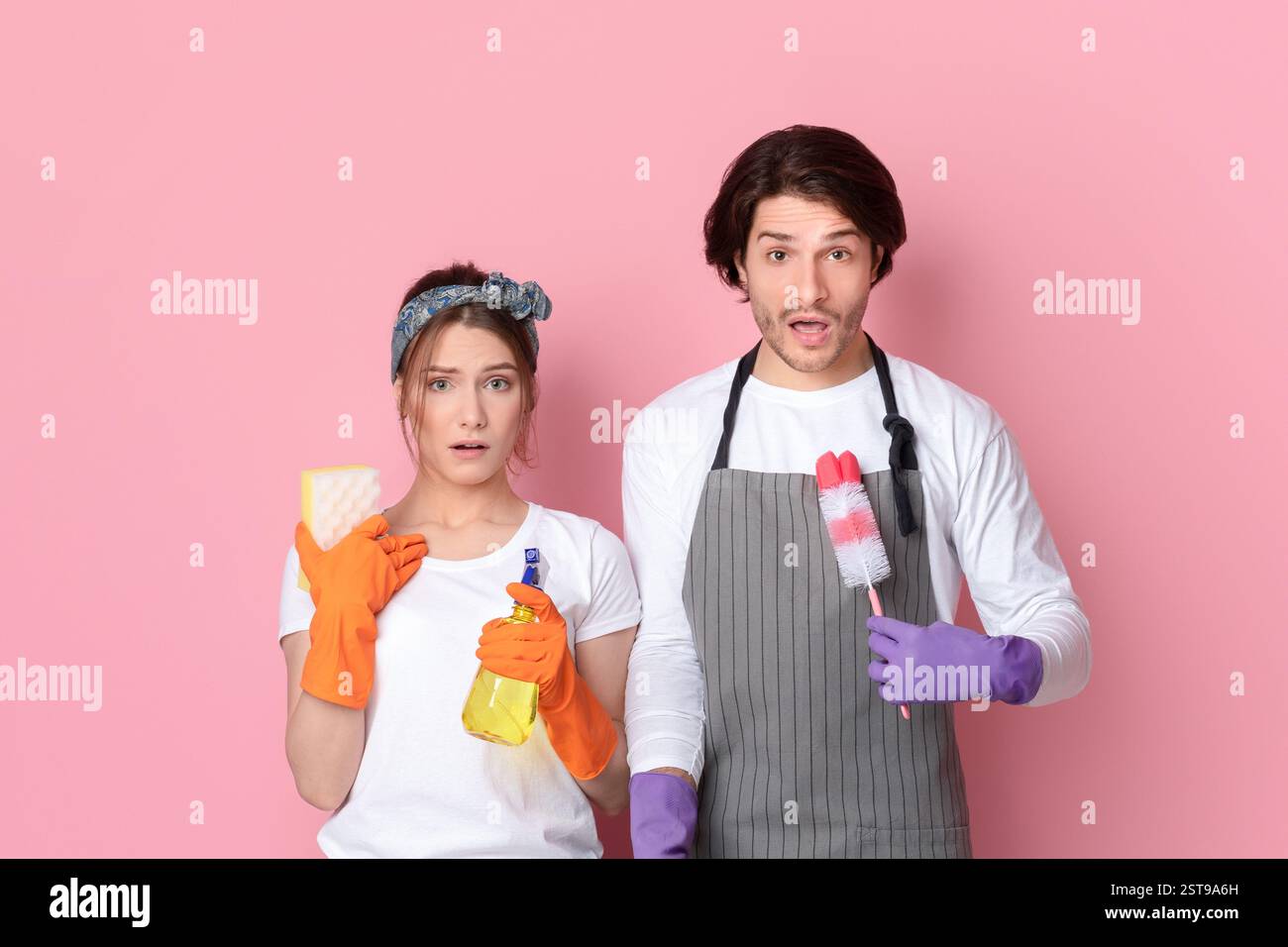 Couple With Cleaning Tools In Hands Looking With Shock At Camera Stock ...