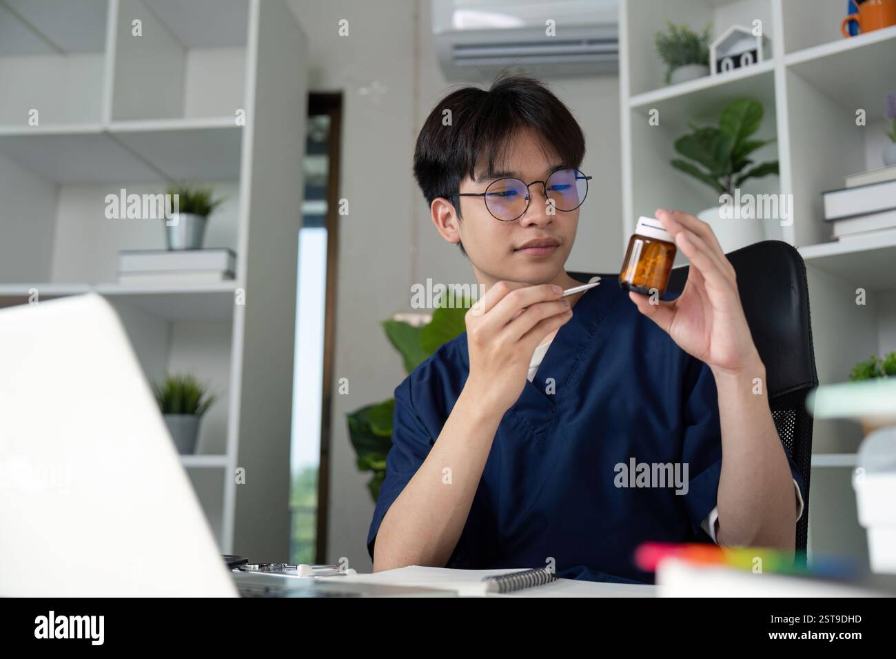 Medical student studying medication management in a modern office ...