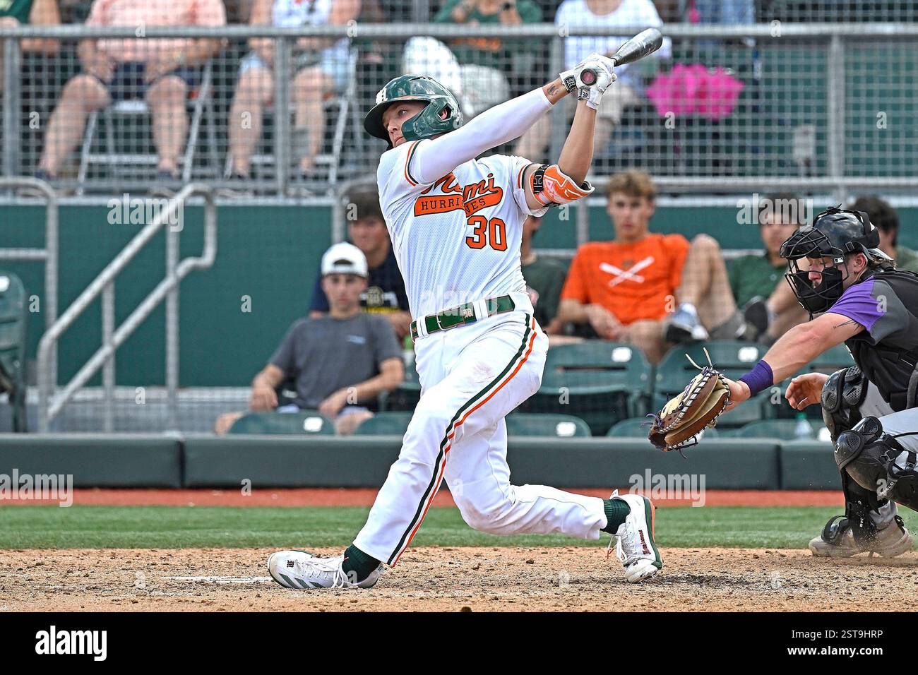 CORAL GABLES, FL - FEBRUARY 16: Miami catcher Tanner Smith (30) bats in ...