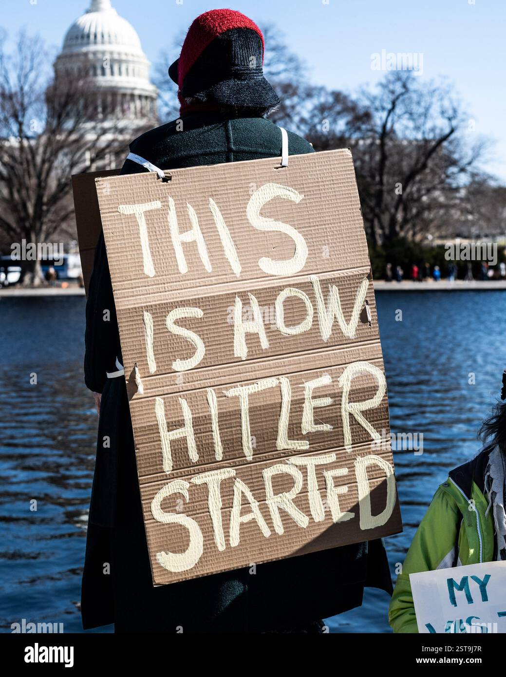 Washington, United States. 17th Feb, 2025. A protester holds a placard ...