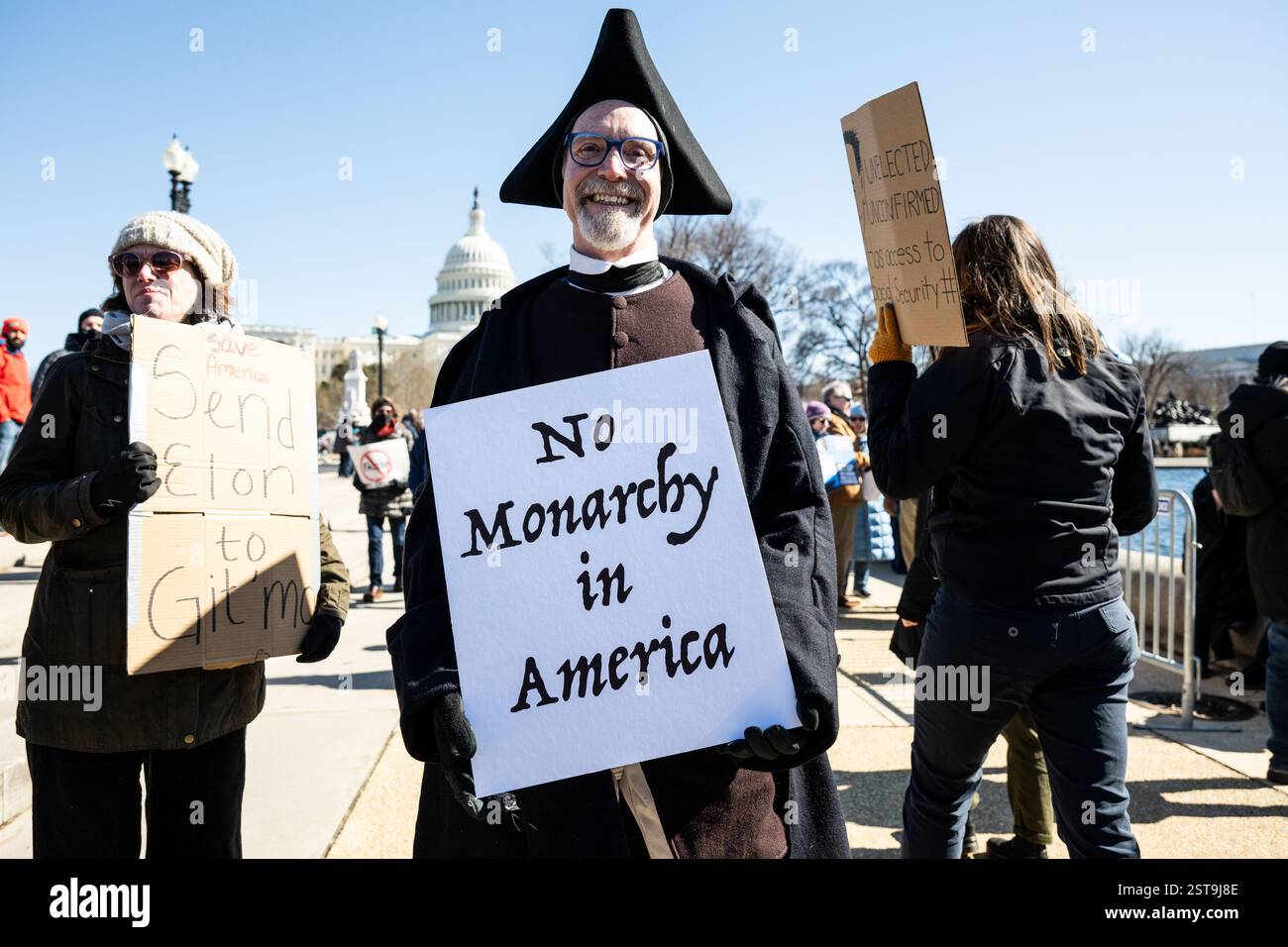 Washington, United States. 17th Feb, 2025. A man holds a placard saying ...