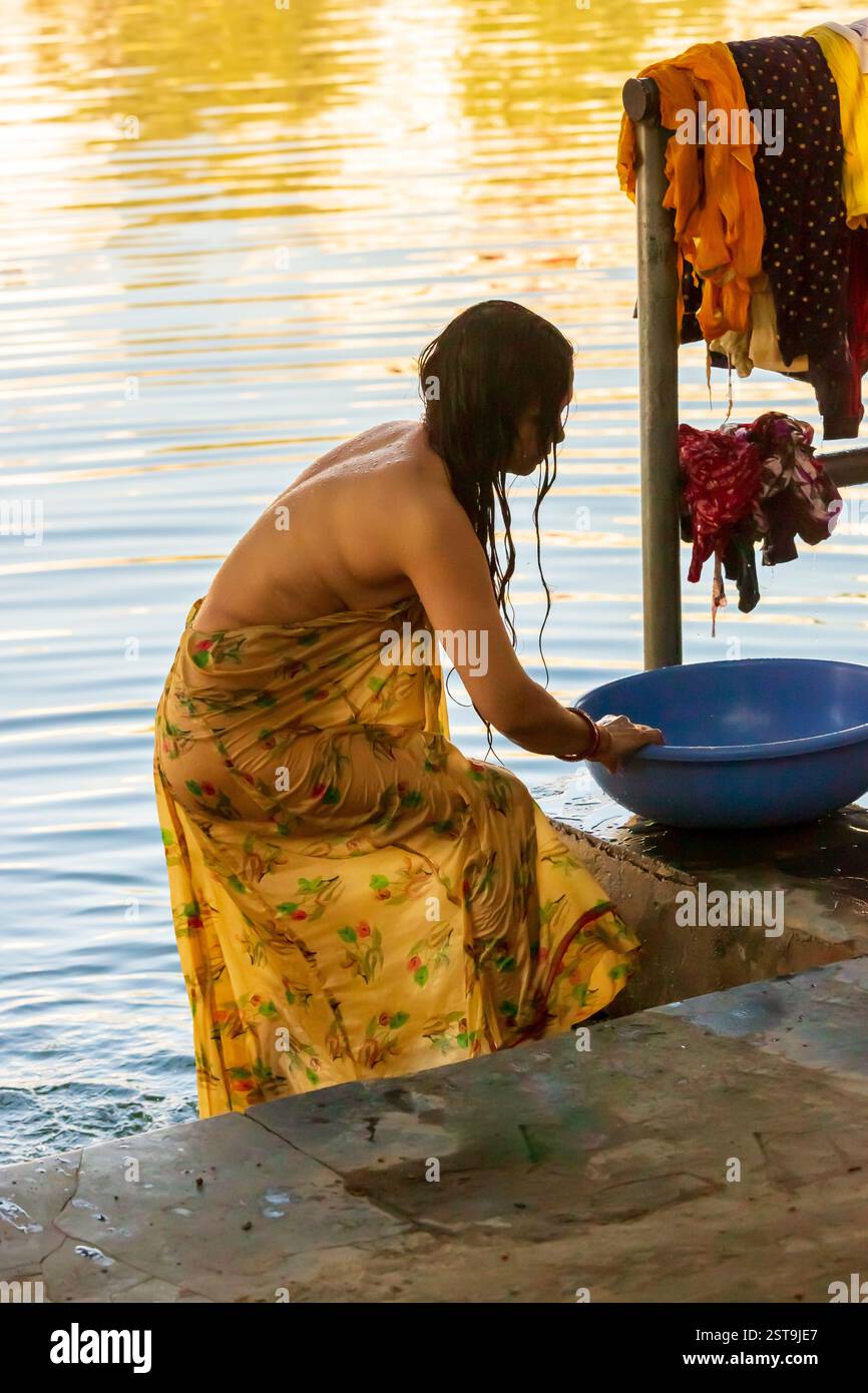Indian woman washing clothes outside hi-res stock photography and ...