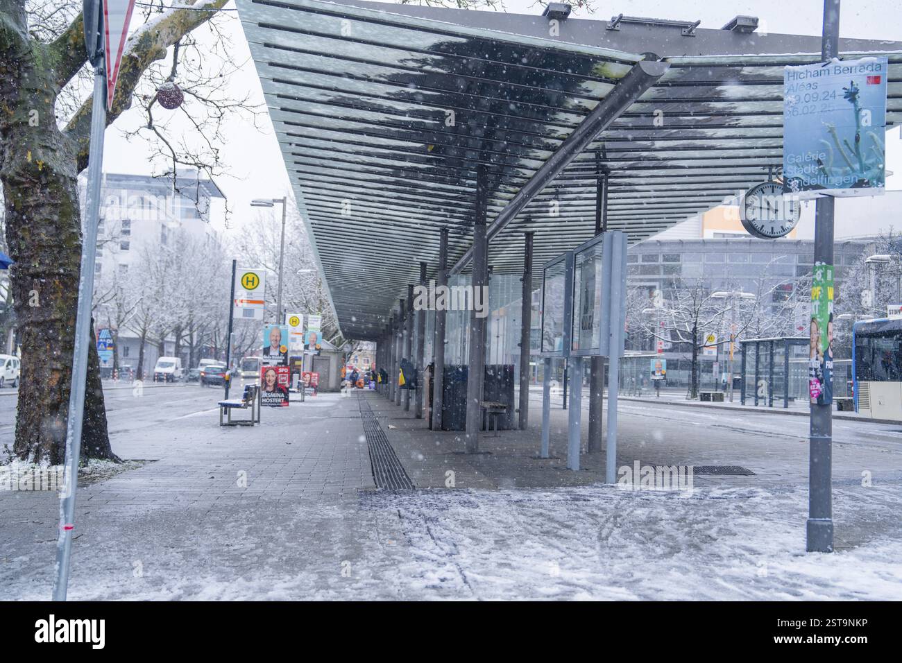 Snowy and empty bus stop in urban area with trees, Sindelfingen ...
