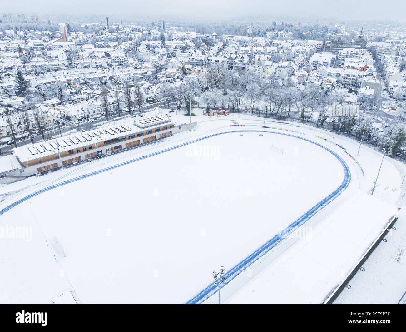 Ice rink seen from above, surrounded by a snowy cityscape, Sindelfingen ...