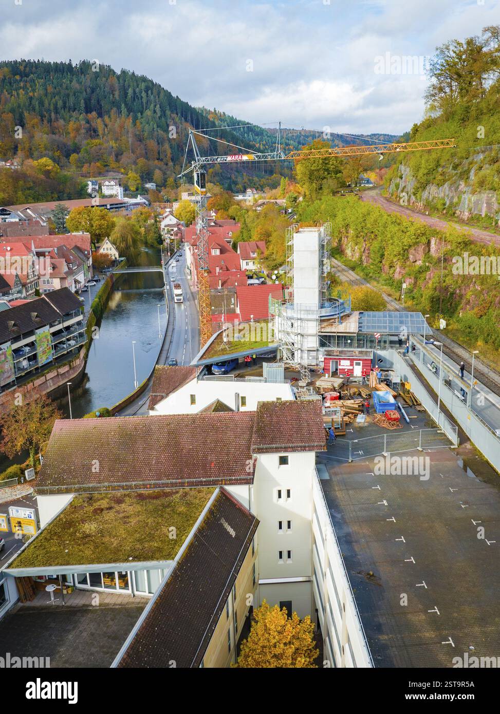 City view with river, buildings and construction crane, surrounded by ...