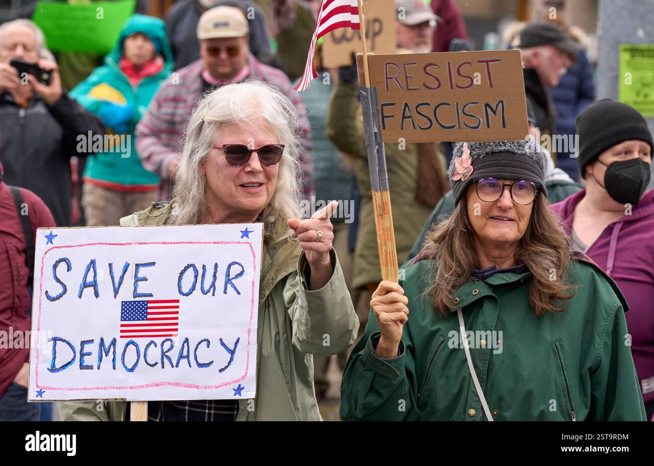 Women hold signs in a pro-democracy demonstration in Eugene, Oregon ...