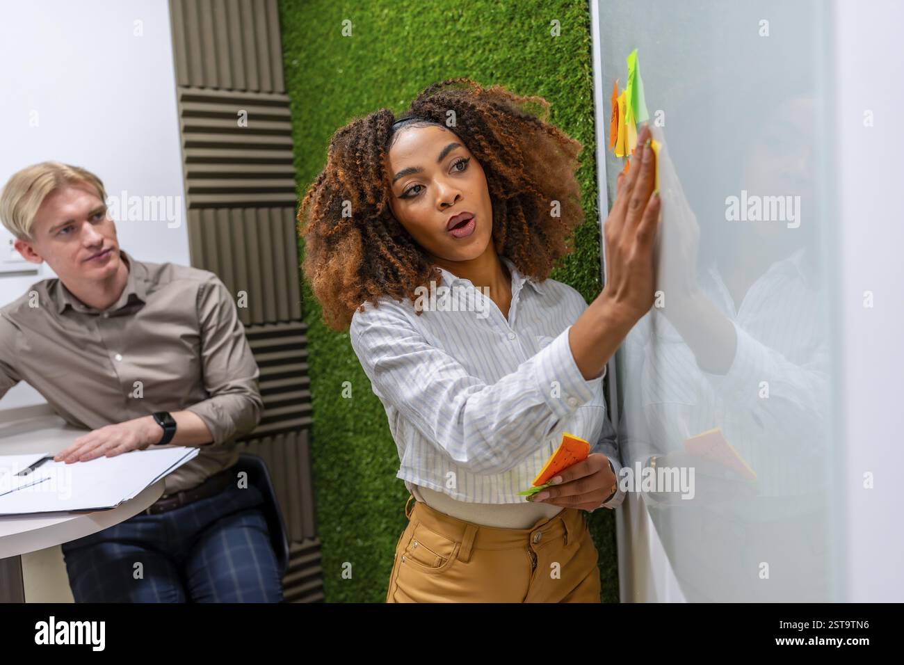Businesswoman Using Colorful Sticky Notes While Brainstorming New Ideas