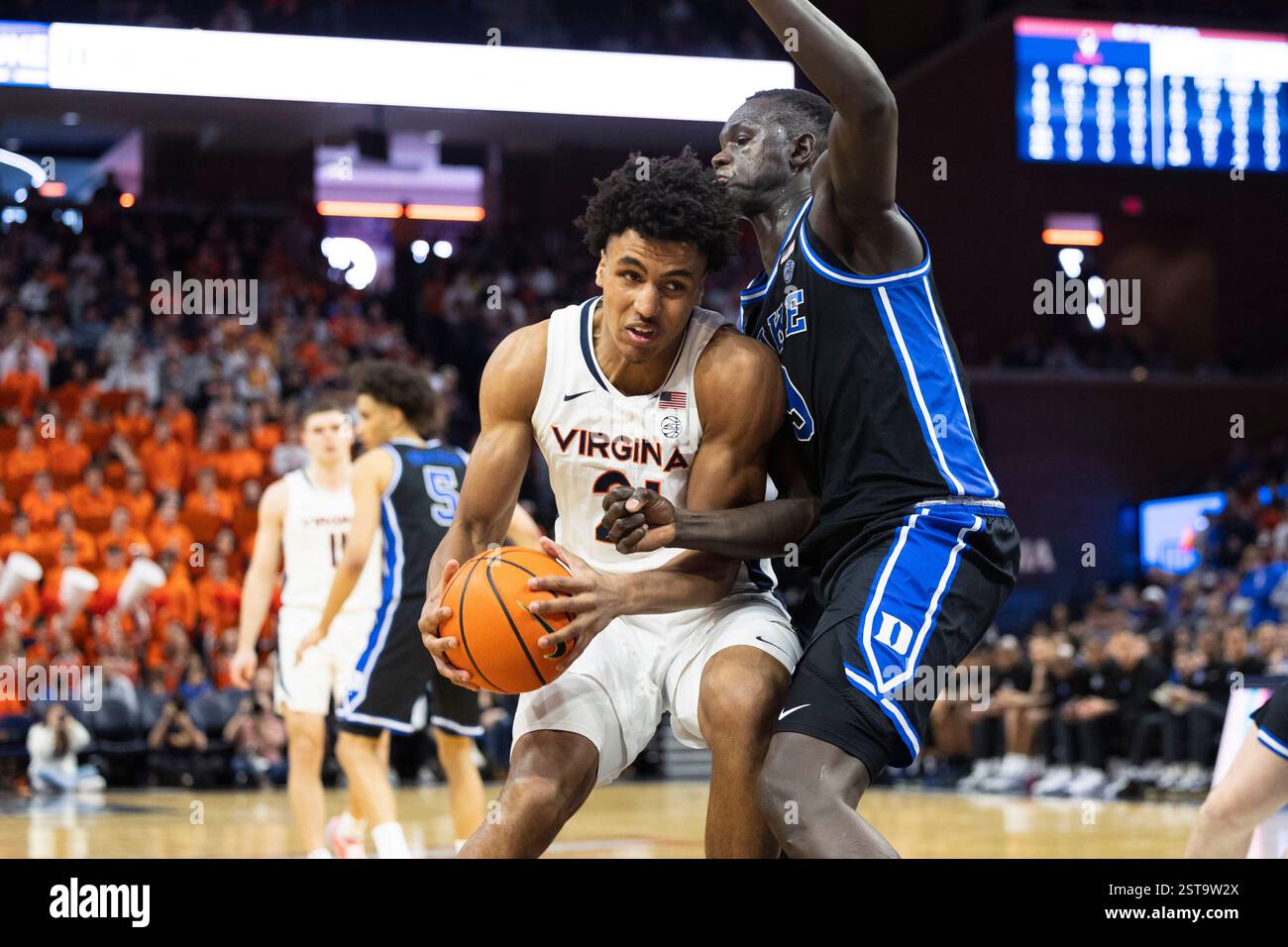 Virginia forward Anthony Robinson defends the ball from Duke center ...