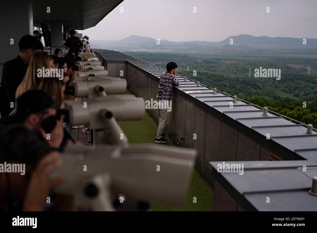 FILE - Tourists use binoculars to view North Korea from the Dora ...
