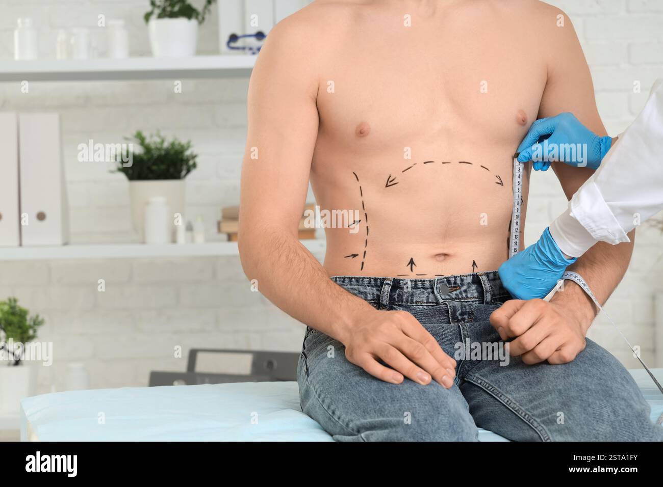Female plastic surgeon working with young man in clinic Stock Photo - Alamy