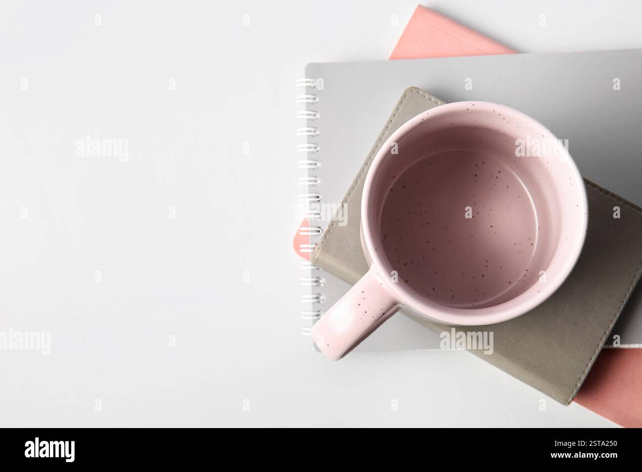 Ceramic mug, notebook and books on white background Stock Photo - Alamy
