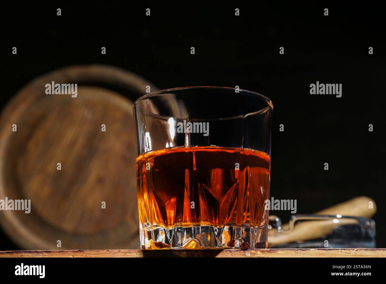 Glass of cold rum near barrel on black background, closeup Stock Photo ...