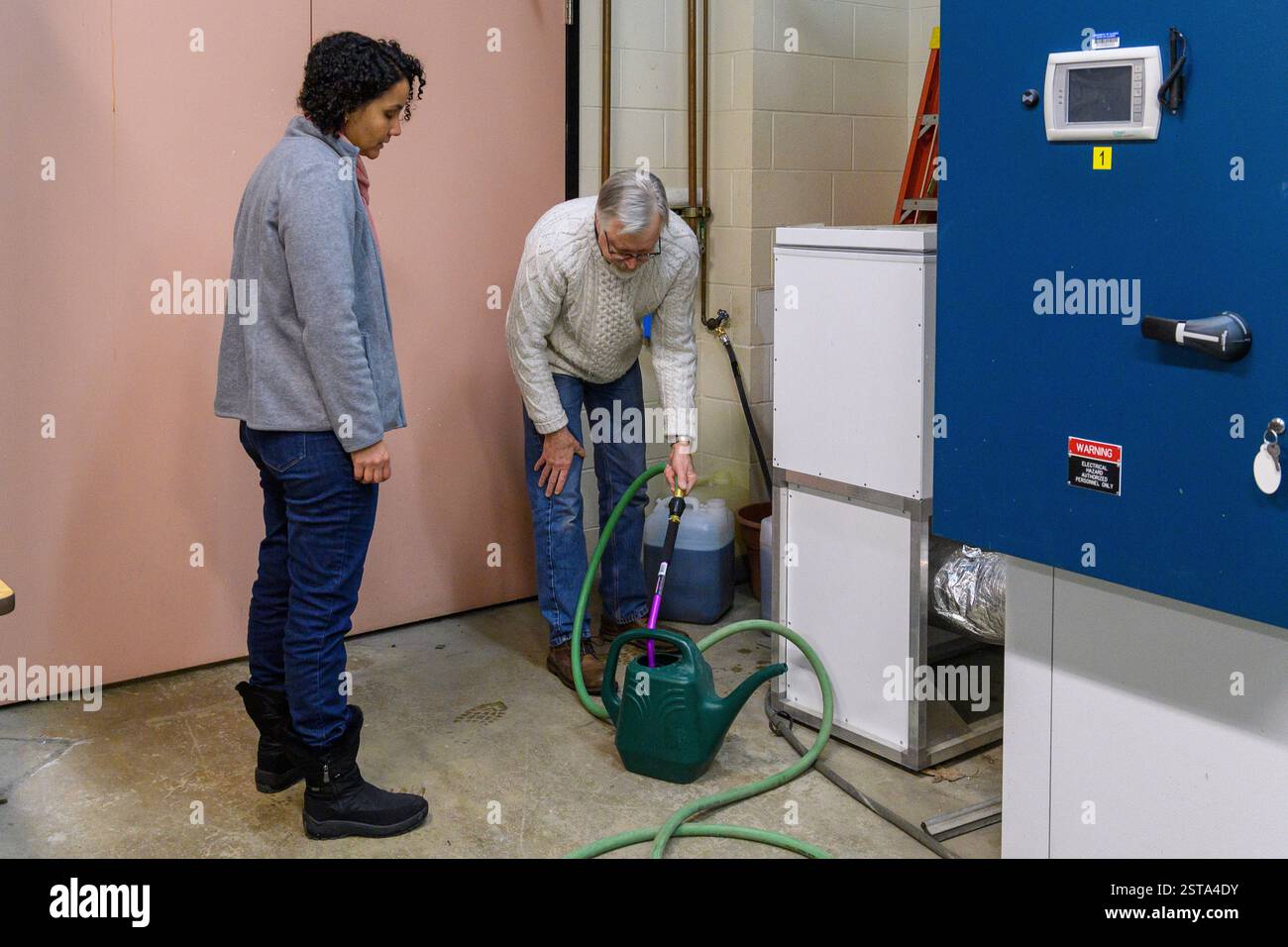 Dr. Michelle da Fonseca, left, and Dr. Brian Diers prepare to water ...