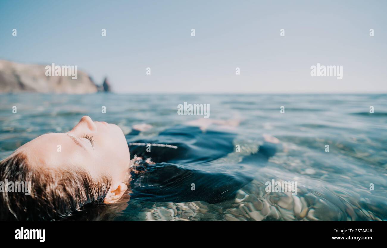 Woman peacefully floating in swimming hi-res stock photography and ...