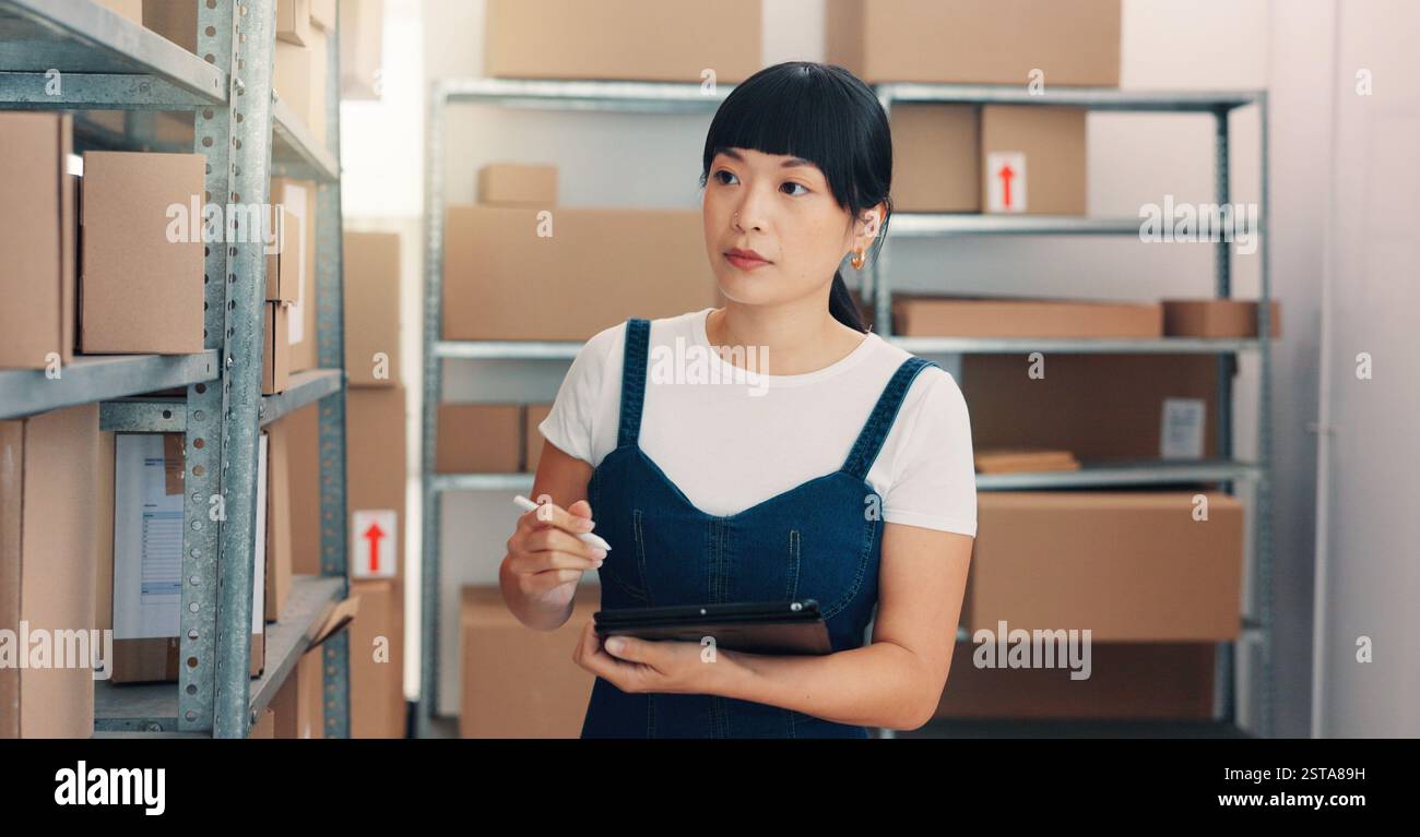 Tablet, shipping and box with Asian woman in warehouse for storage ...