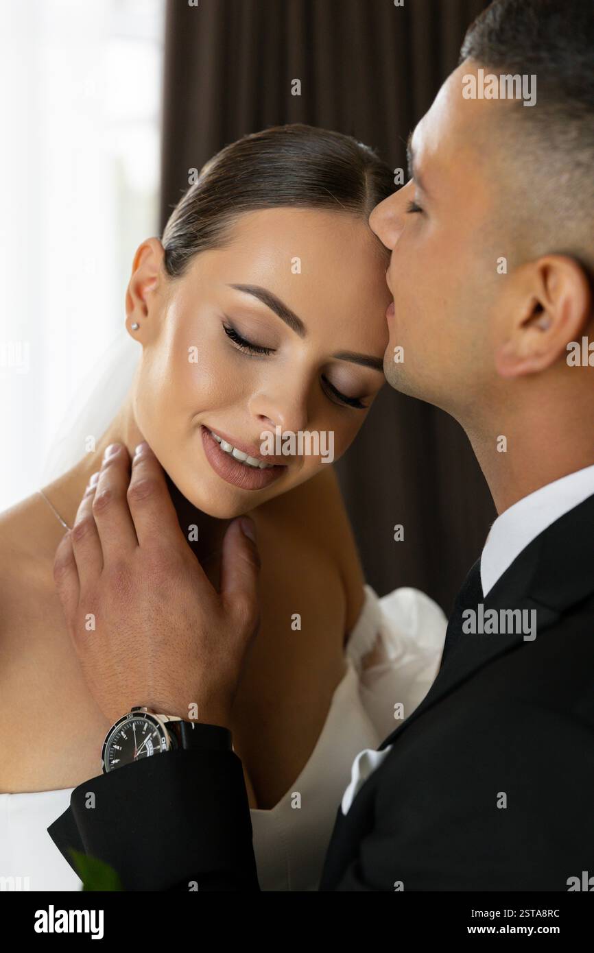 Newlywed couple sharing an intimate moment, celebrating their love and commitment on their ...