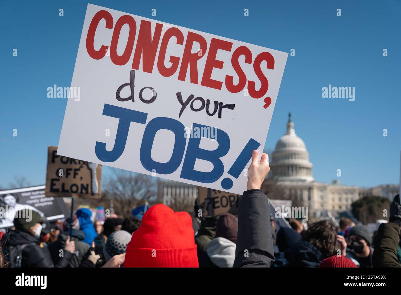 Washington, United States. 17th Feb, 2025. A protestor holds a placard ...