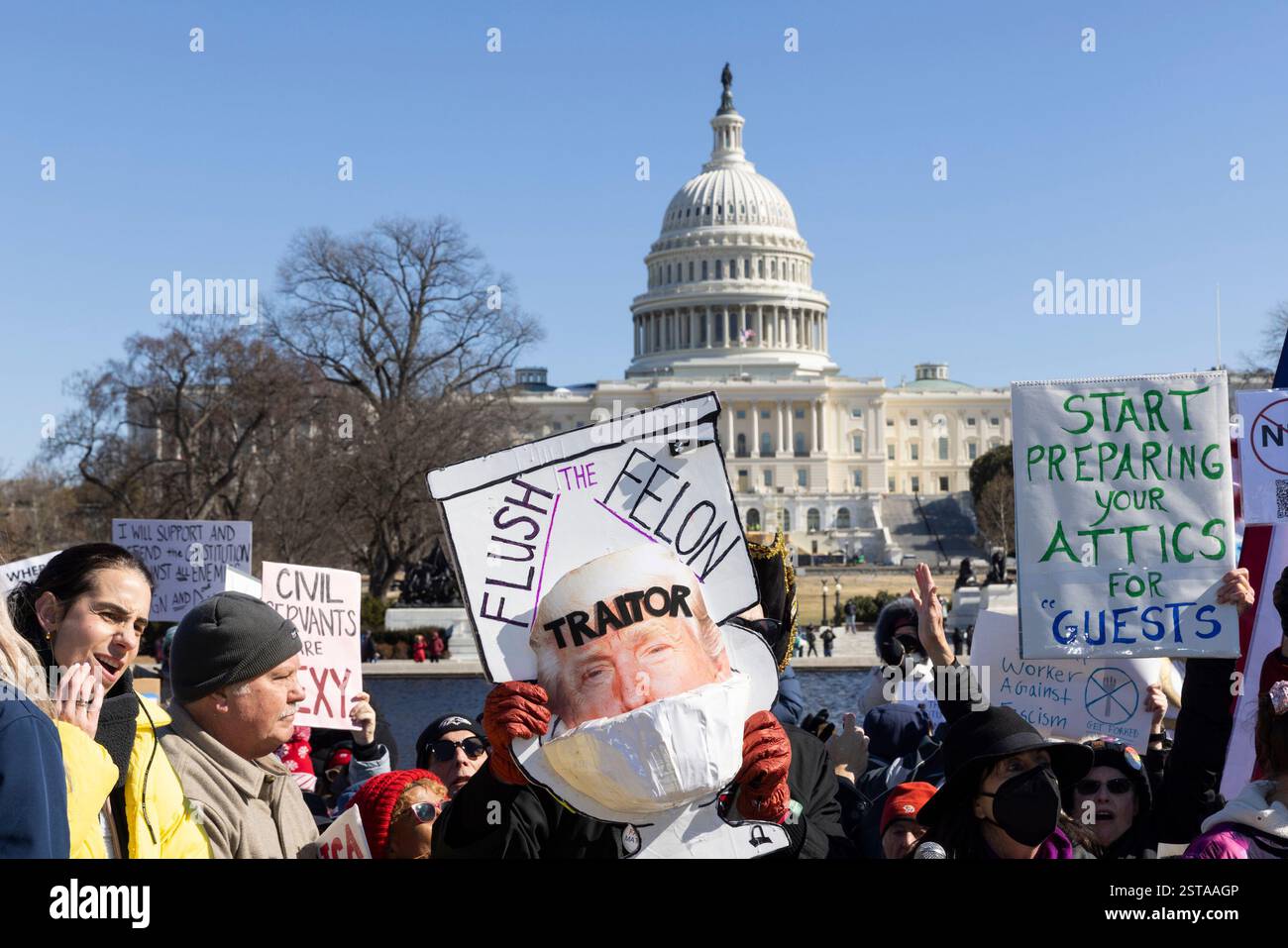 Protesters hold signs during the rally against the Donald Trump ...