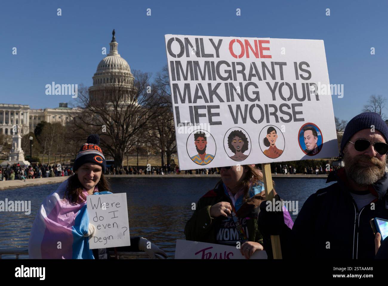 Protesters hold signs during the rally against the Donald Trump ...