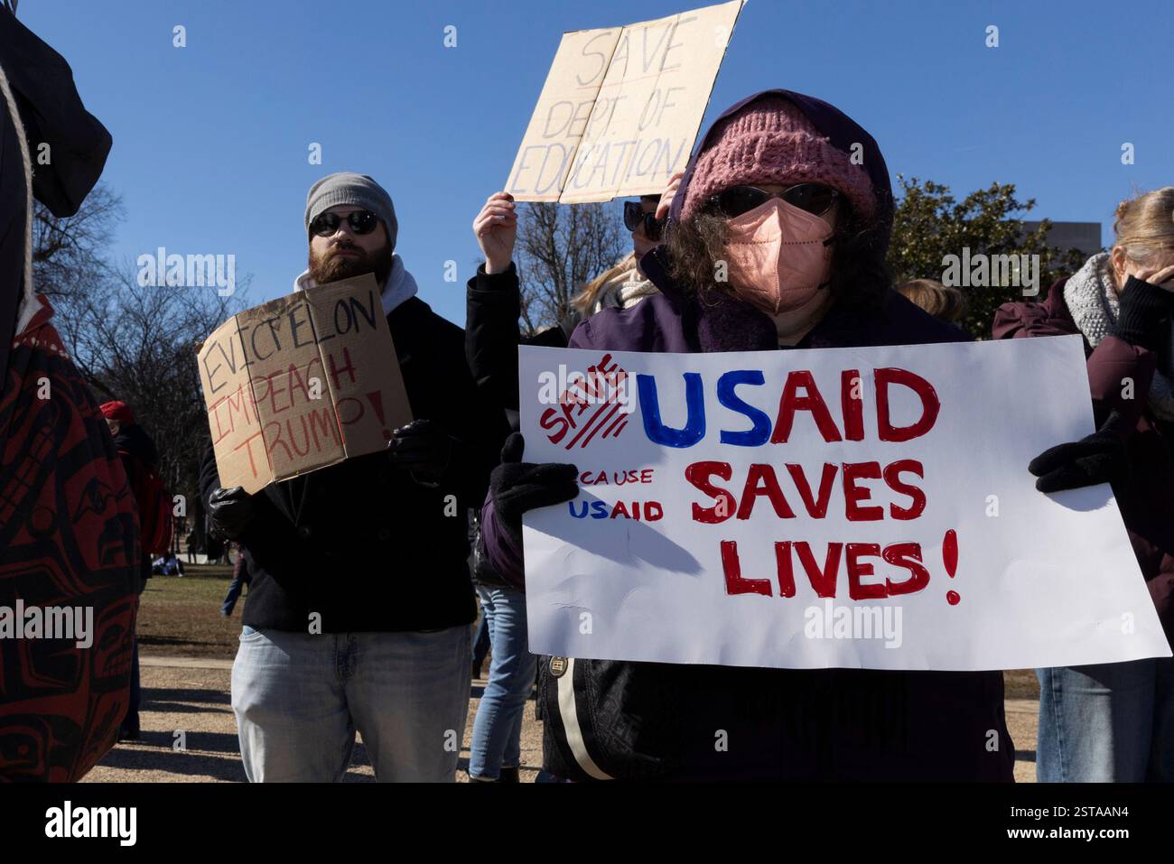 Protesters hold signs during the rally against the Donald Trump ...