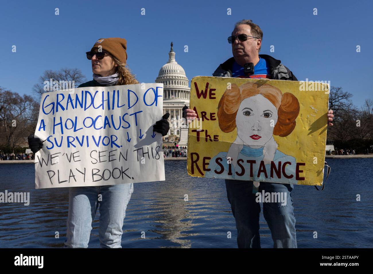 Protesters hold signs during the rally against the Donald Trump ...