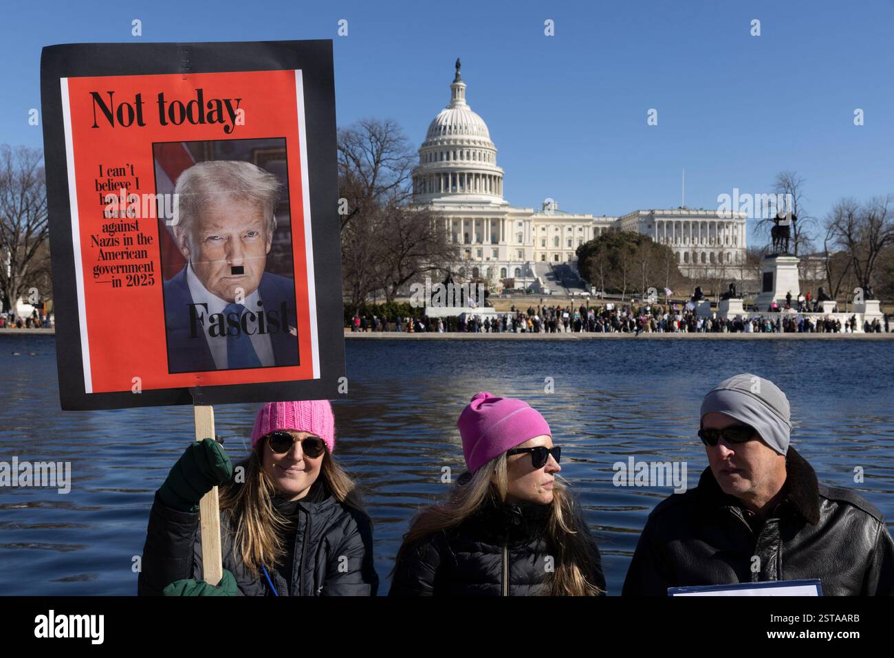 A protester holds a sign during the rally against the Donald Trump ...