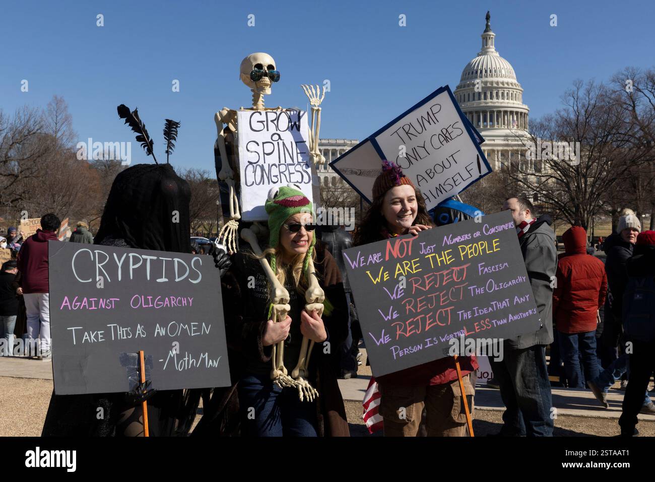 Protesters hold signs during the rally against the Donald Trump ...
