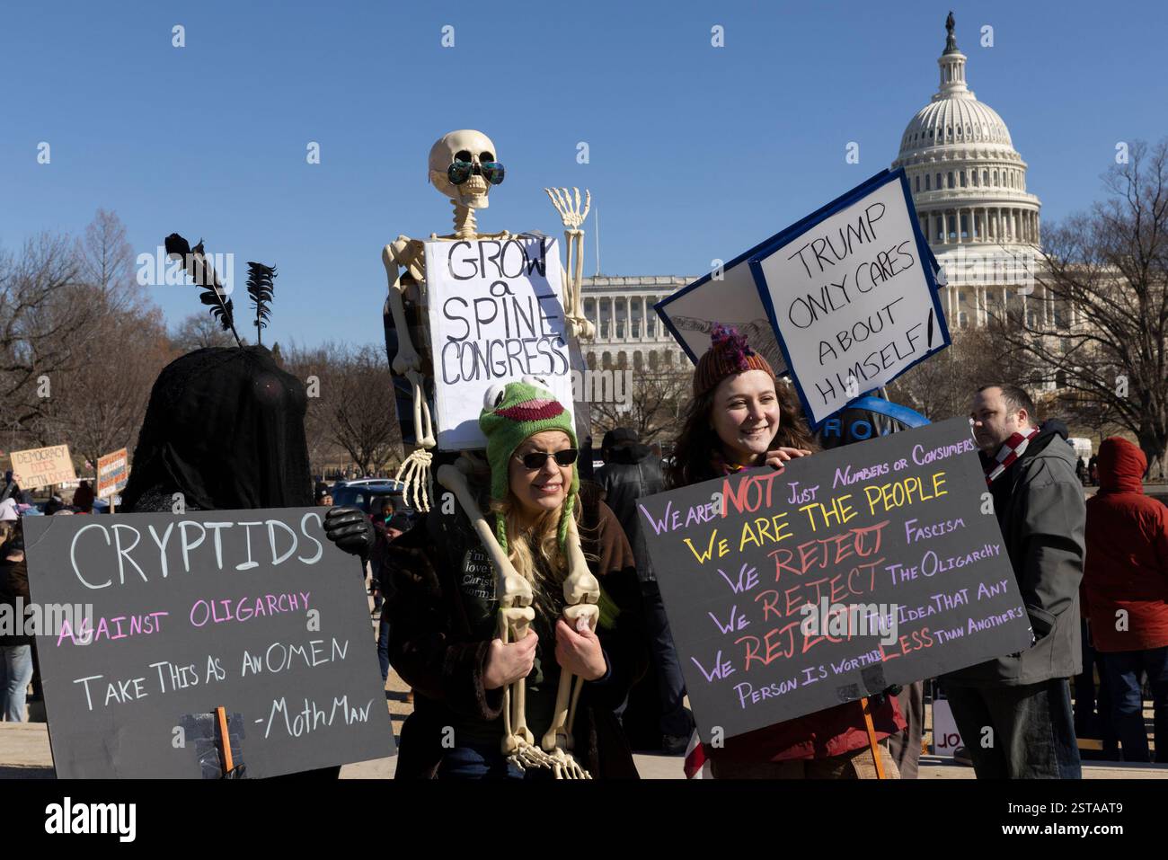 Protesters hold signs during the rally against the Donald Trump ...